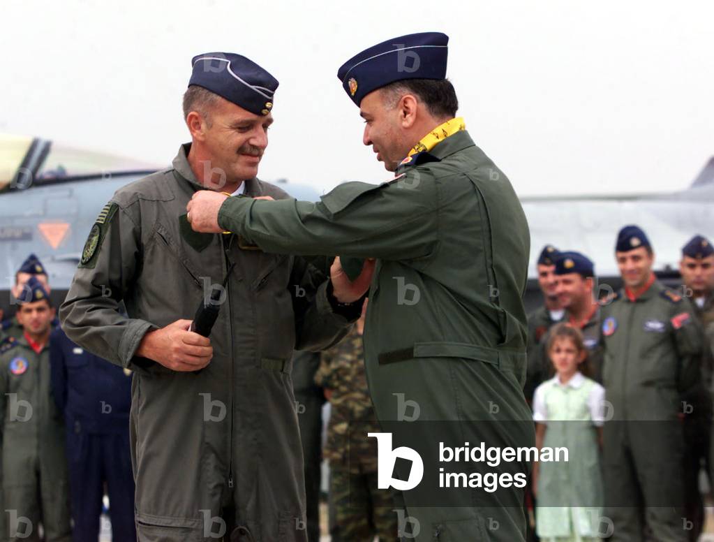 Image of TURKISH AND GREEK FIGHTER PILOTS STAND IN FRONT OF A