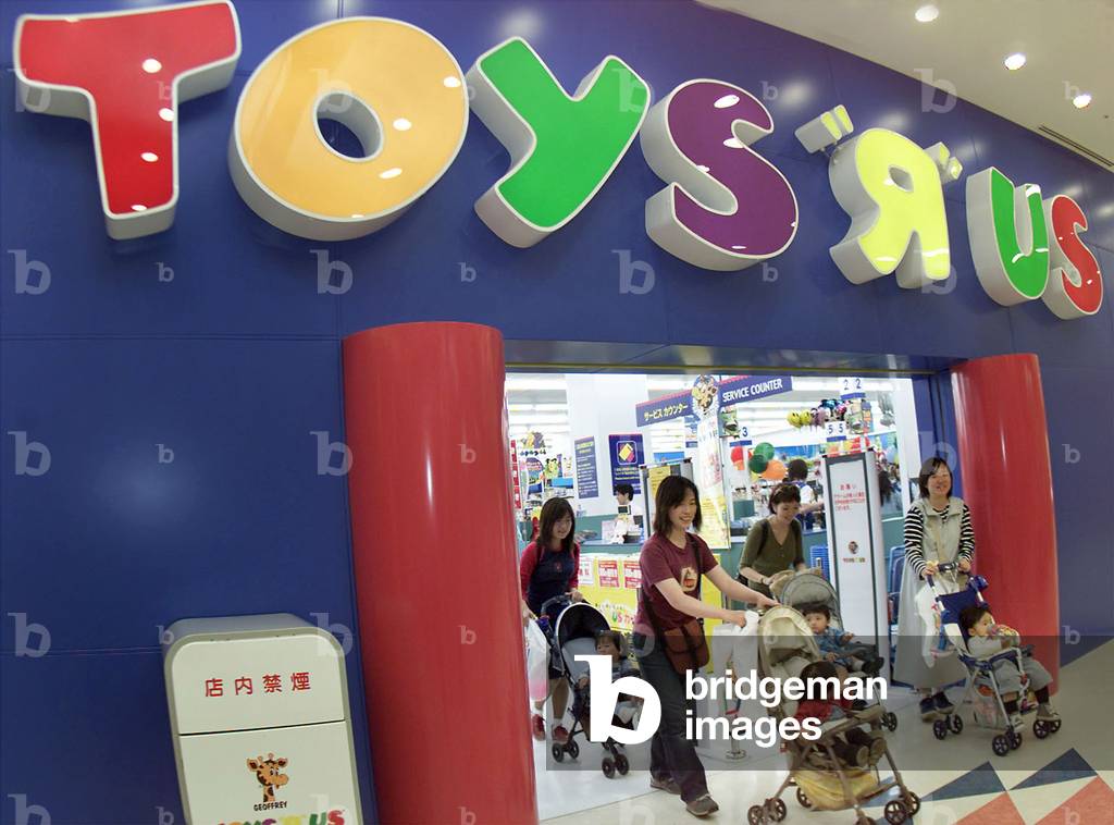 Image of Japanese shoppers exit American toystore giant Toys R Us' Odaiba