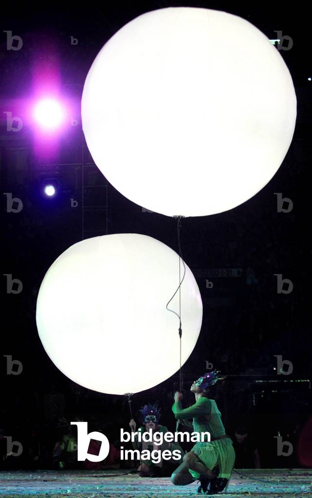 Image of Performers carry large lanterns as part of the opening ceremonies
