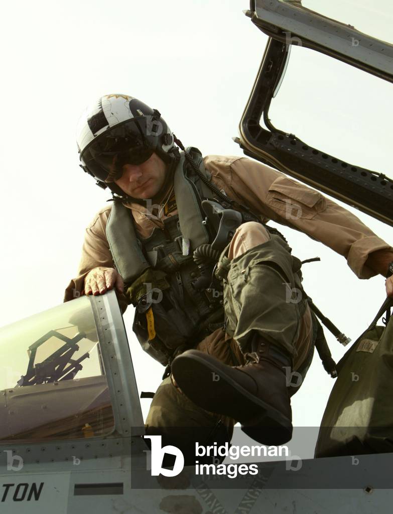 Image of F/A-18 PILOT GESTURES FROM COCKPIT ABOARD THE USS KITTY HAWK