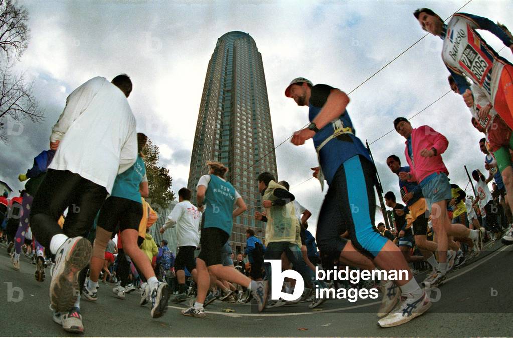 Image of Runners pass the Frankfurt fair tower, which is Europe's tallest