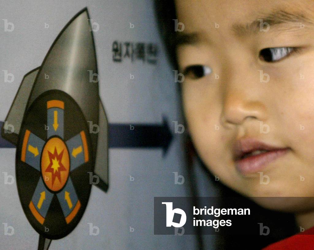 Image of A SOUTH KOREAN CHILD LOOKS AT THE SYMBOL OF THE