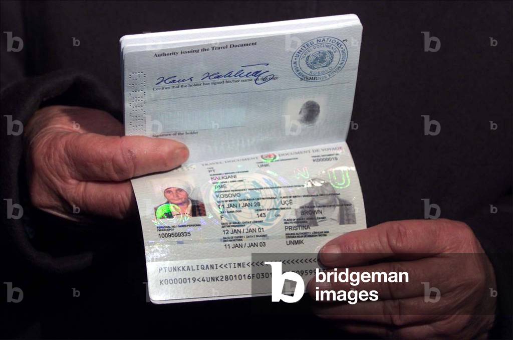 Image of A Kosovo Albanian woman holds the first United Nations travel