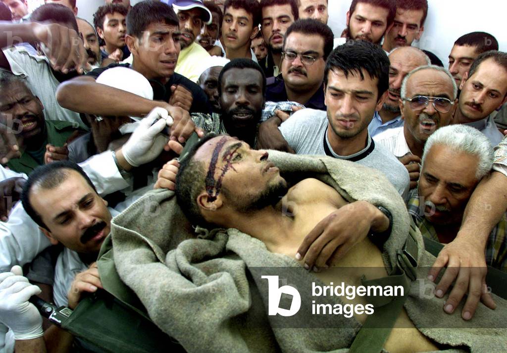 Image of Palestinians carry to hospital the body of Amean Abu Hatab