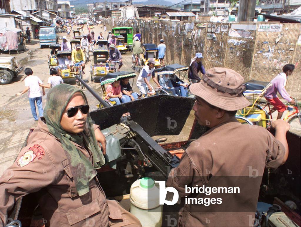 Image of PHILIPPINE POLICE ABOARD AN ARMOURED CARRIER PATROL DOWNTOWN ...