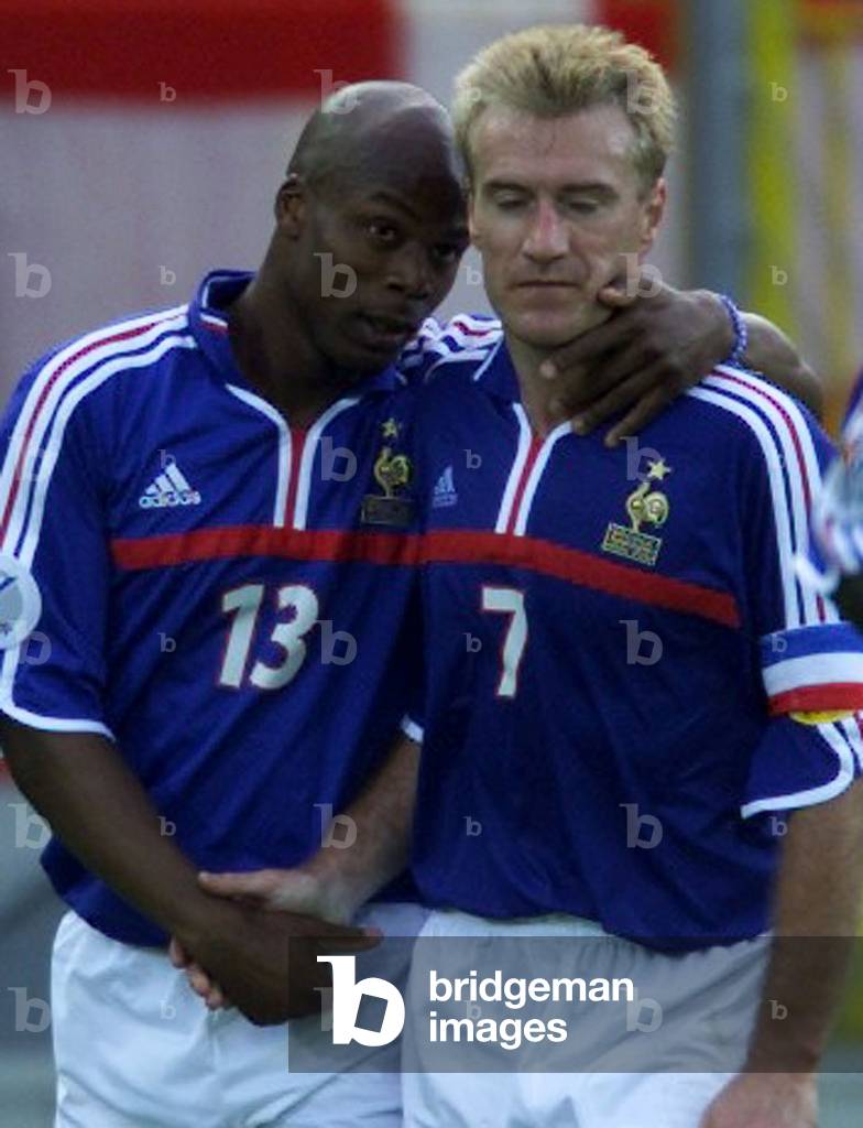 Image of French captain Didlier Deschamps (R) gets a hug from goal