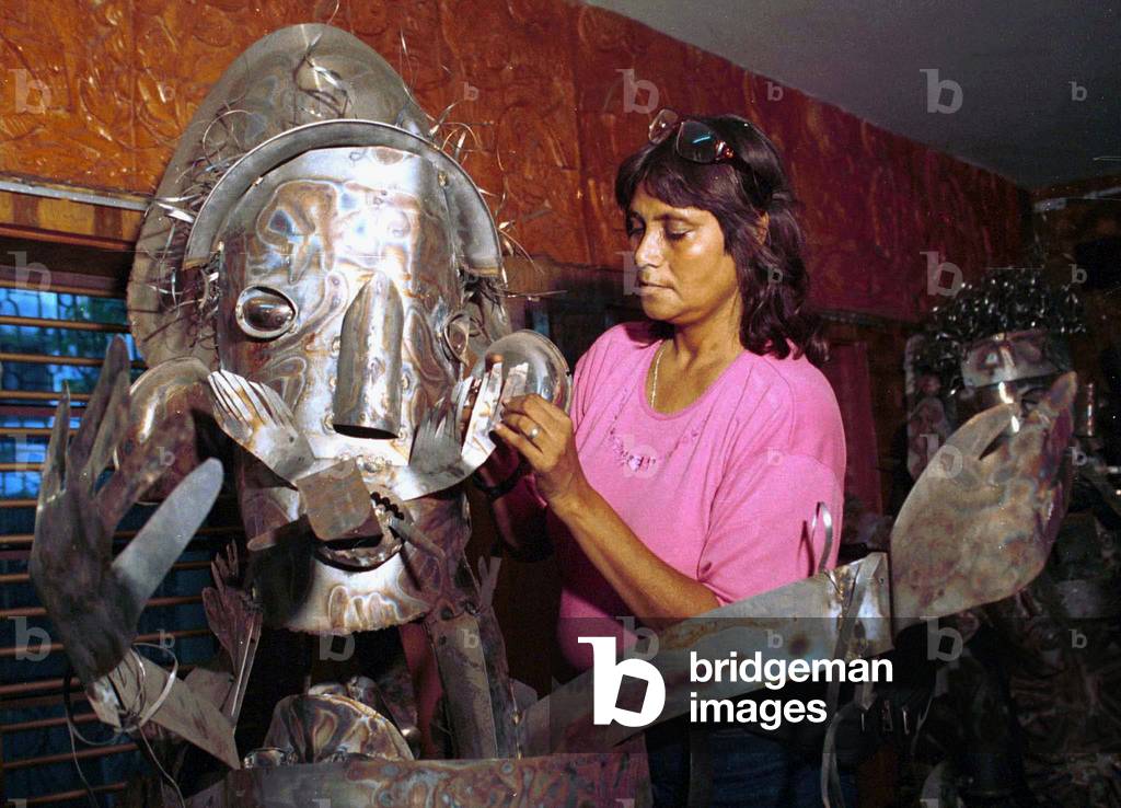 Image of Bangladeshi sculptor Shamim Sikder works on a bronze sculpture ...