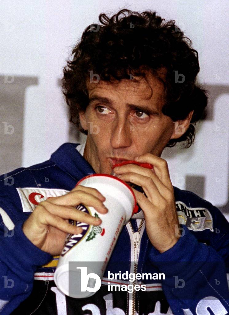 Image of Alain Prost takes time for a drink during the practice