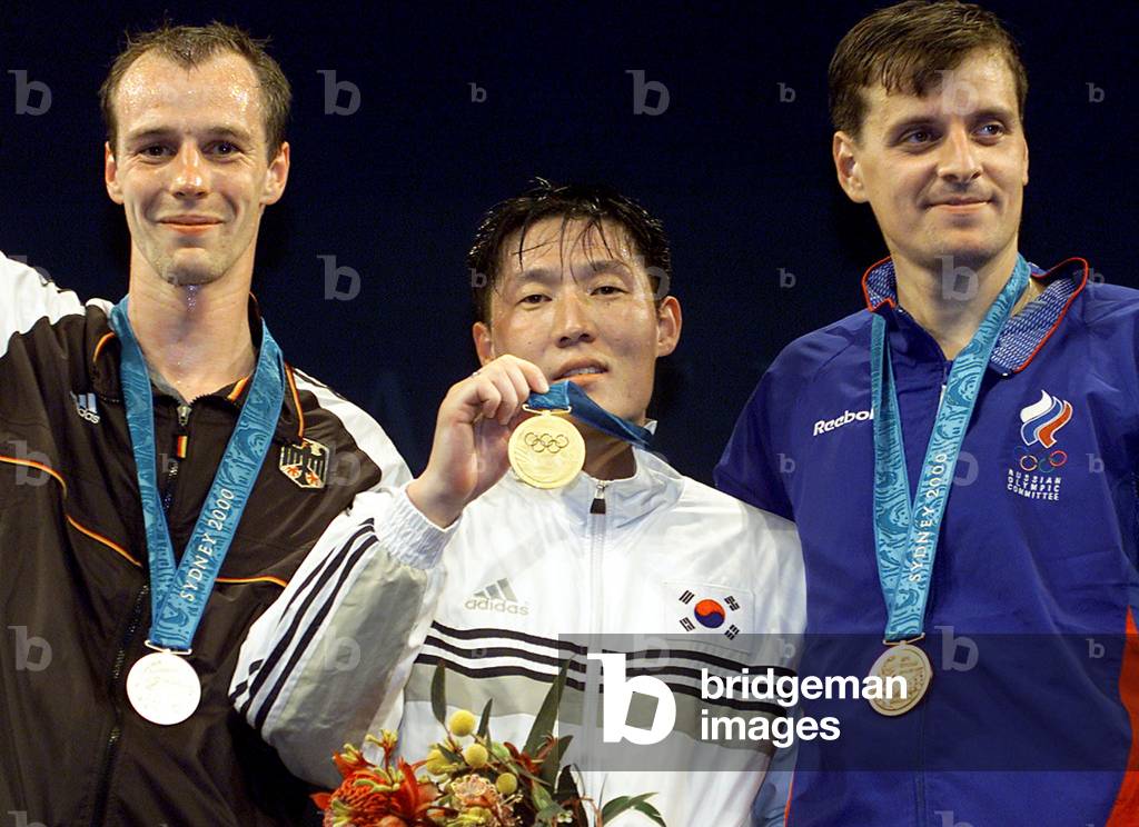 Image of KIM YOUNG-HO OF SOUTH KOREA HOLDS HIS OLYMPIC GOLD MEDAL