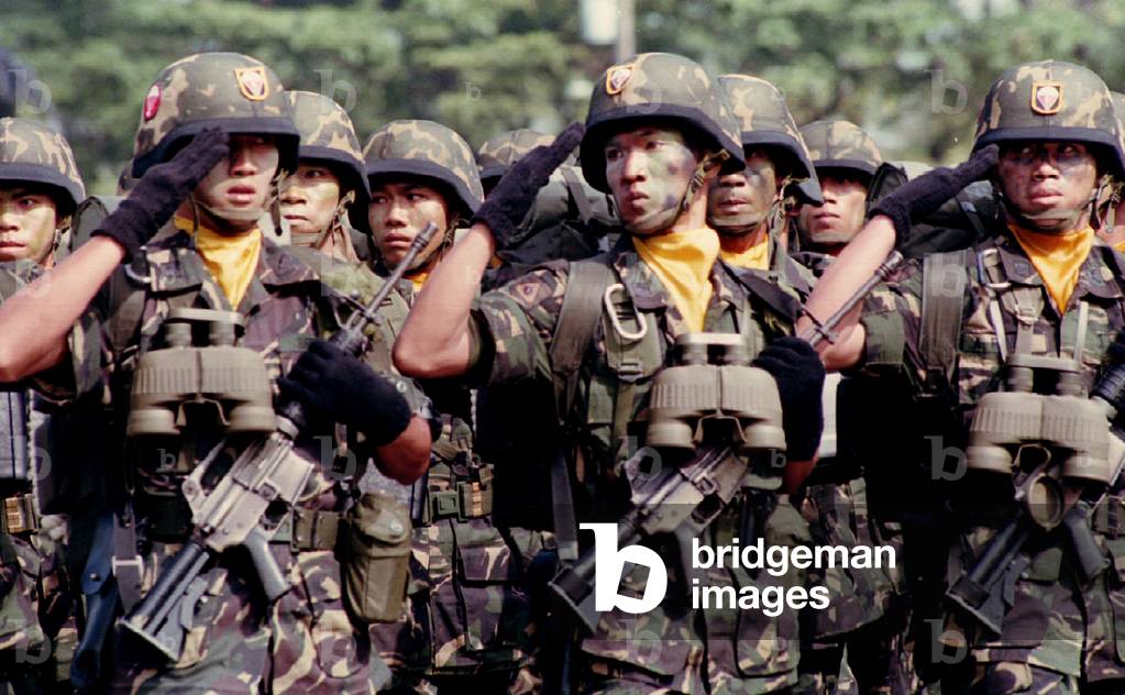 Image of Army soldiers with their armalite rifles salute while marching ...