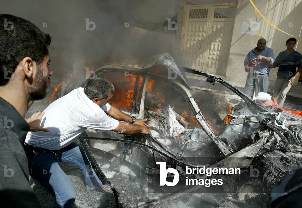 Image of PALESTINIANS TRY TO PULL OUT A DEAD BODY AFTER AN Image of PALESTINIANS TRY TO PULL OUT A DEAD BODY AFTER AN