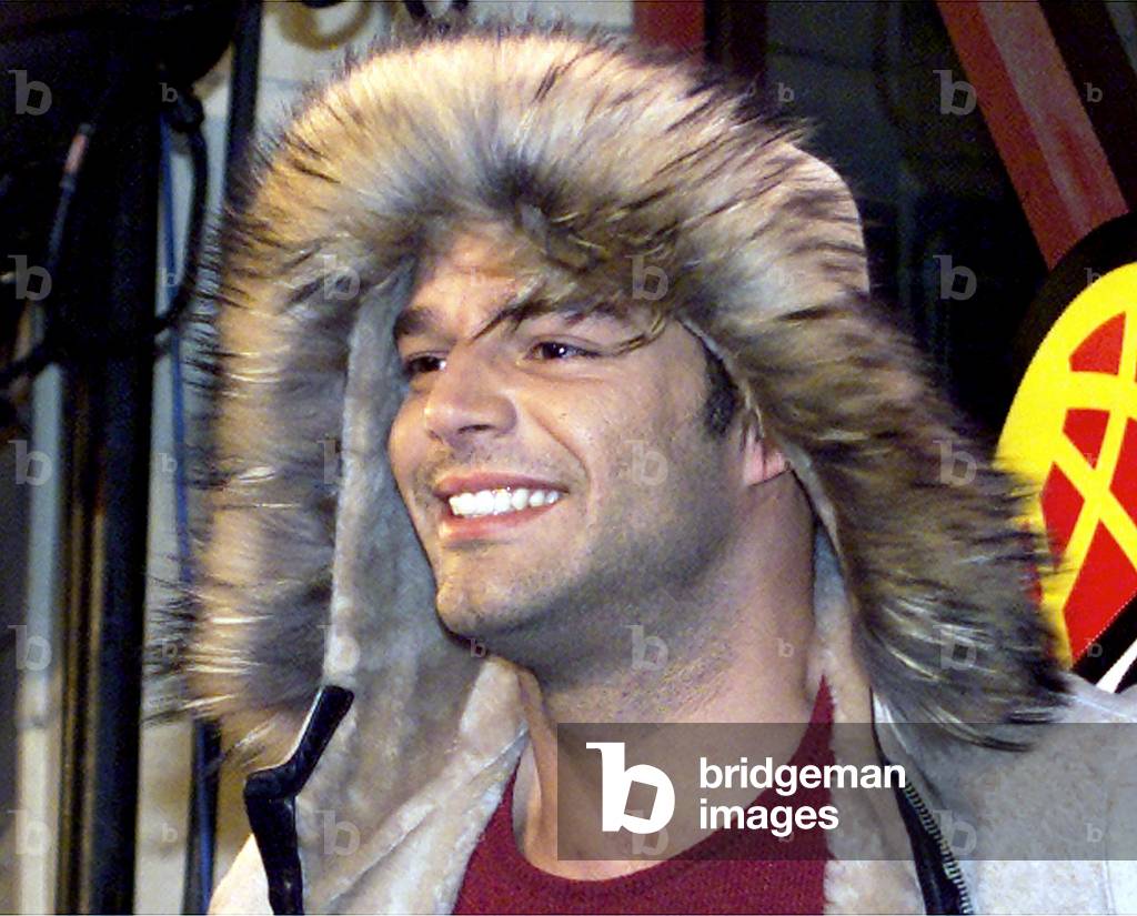 Image of Pop singer Ricky Martin wears a fur-trimmed hood during the