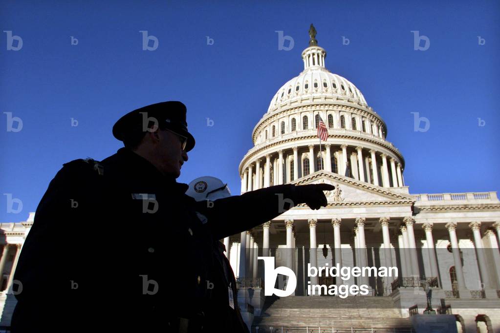 Image of A Capitol Hill Police officer informs a worker where he