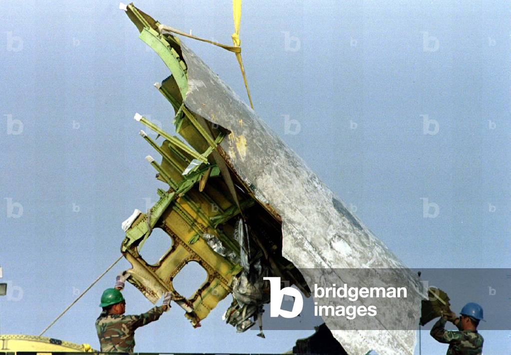 Image of Workers position a section of the fuselage from TWA Flight