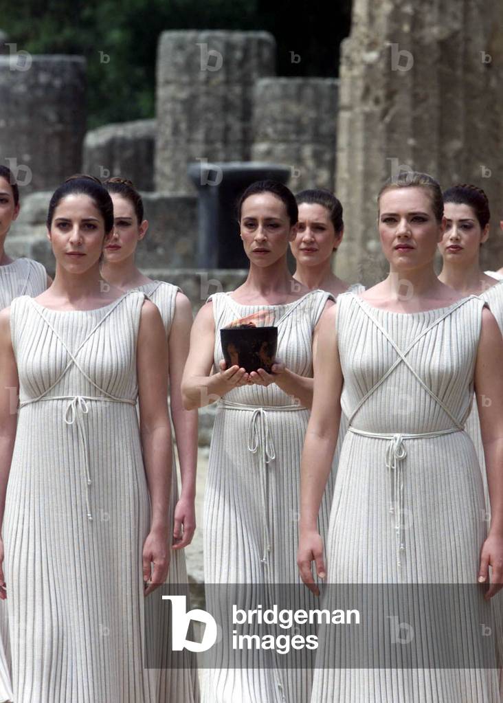 Image of Greek priestesses carry a cauldron with the Olympic flame at