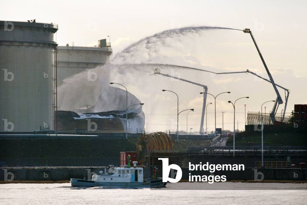 Image of FINAL EXTINGUISHING WORK TO STOP FIRE IN OIL STORAGE TANK