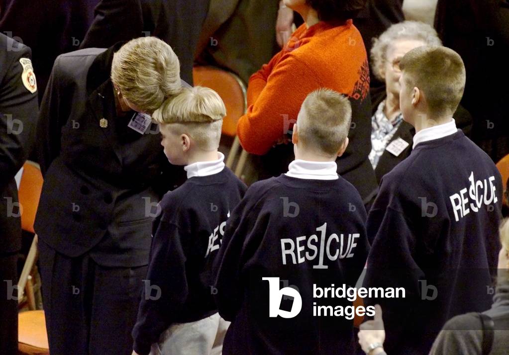 Image of WIDOW OF FIREFIGHTER BROTHERTON RESTS HEAD ON SONS HEAD AT
