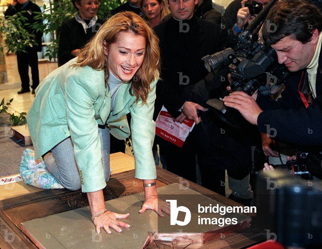 Image of Gymnastics legend Nadia Comaneci from Romania leaves her hand- and