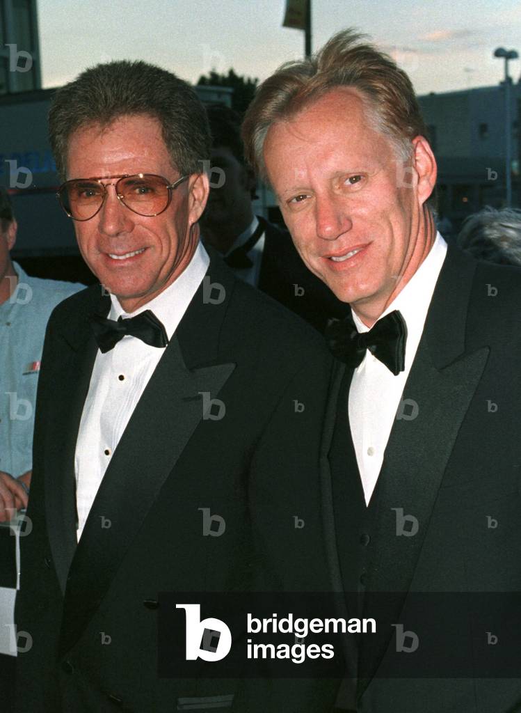 Image of Actor James Woods (R) poses with race car driver Darrell