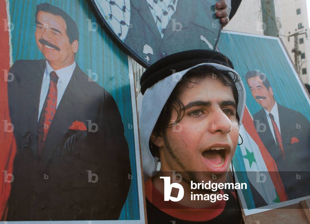 Image of PALESTINIAN TEENAGER HOLDS POSTERS OF IRAQI PRESIDENT SADDAM ...