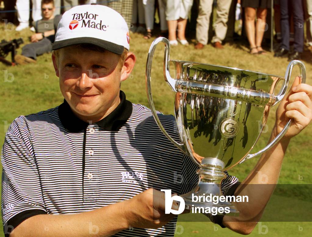 Image of Australia's golfer Stephen Allan displays the winner's trophy ...