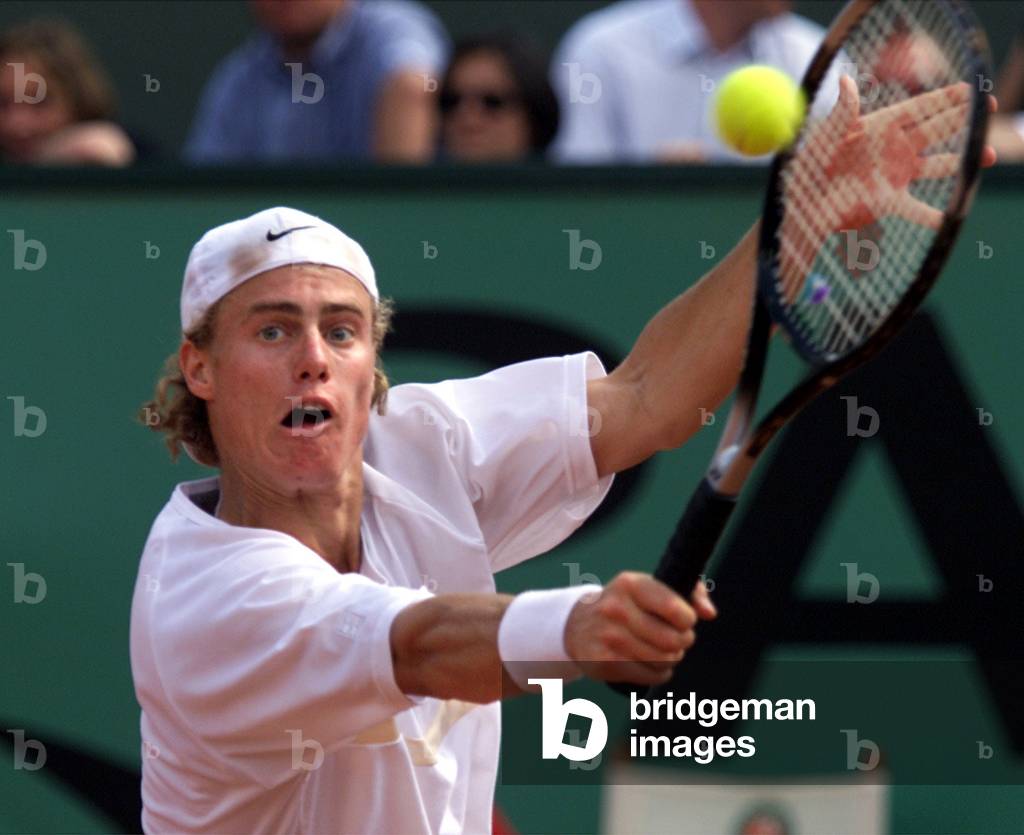 Image of Lleyton Hewitt of Australia returns the ball to [Juan Carlos