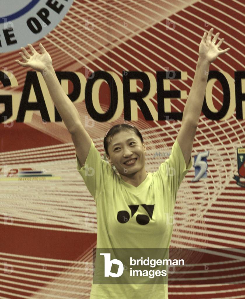 Image of ZHANG NING OF CHINA CELEBRATES AT THE PODIUM AFTER BEATING