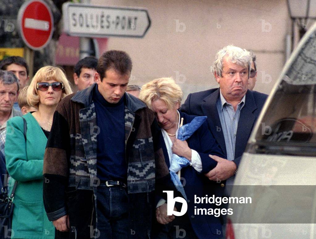 Image of The father (R) and mother (C) of Allan Guillemette, one