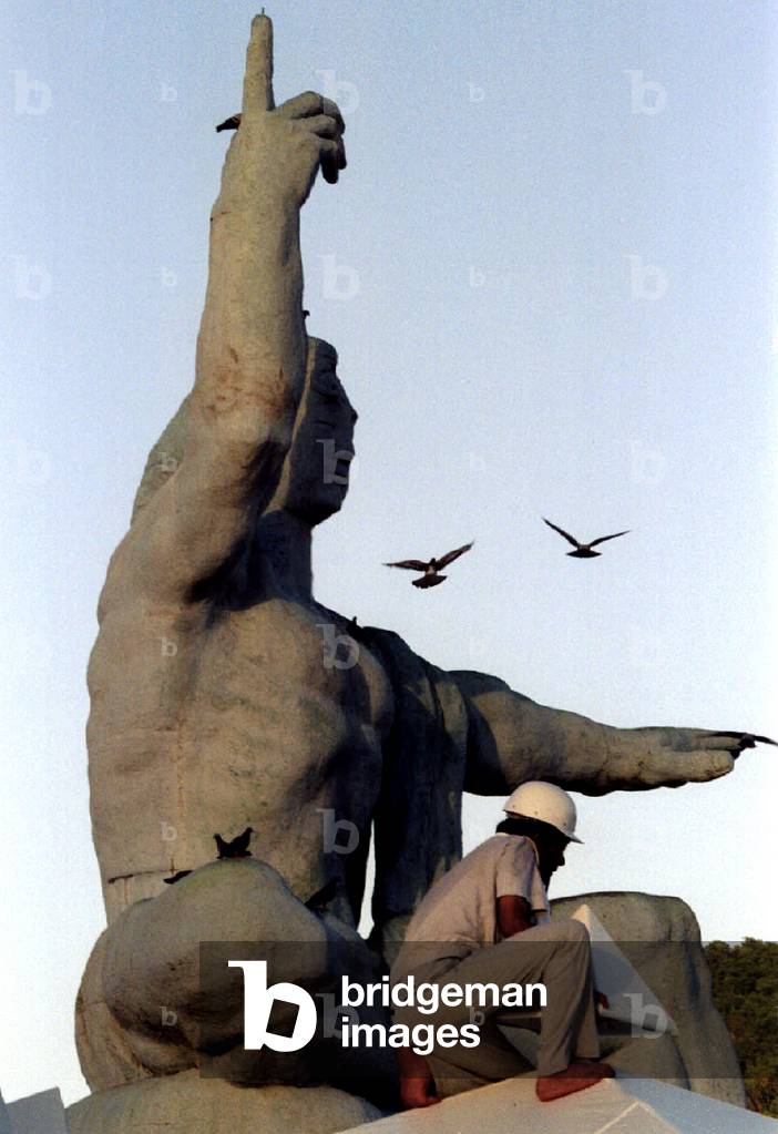 Image of The Peace Statue of Nagasaki city points up into the