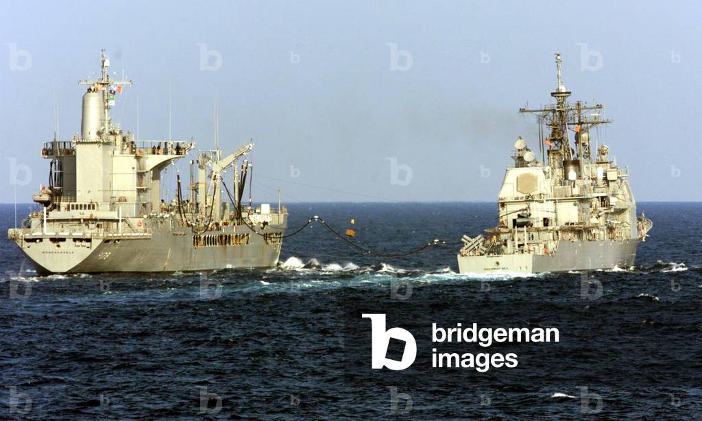 Image of The USS Philippine Sea destroyer (R) is refuelled by the