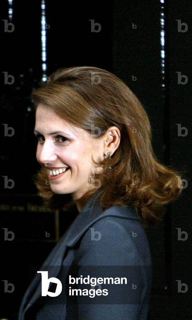 Image of ASMA AL-ASSAD A WIFE OF SYRIAN PRESIDENT BASHAR AL-ASSAD SMILES