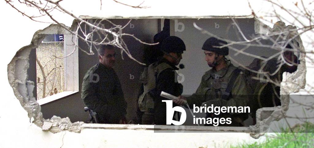 Image of ISRAELI SOLDIERS PREPARE EXPLOIVES TO DEMOLISH THE HOME OF A