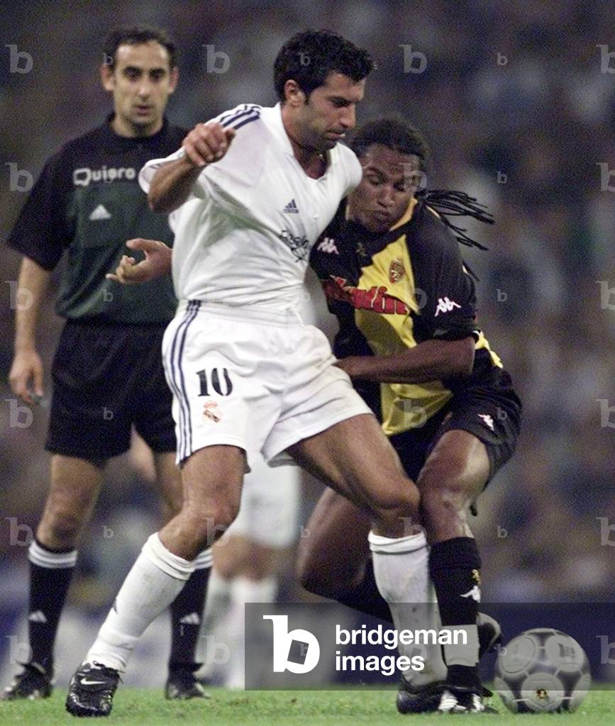 Image of REAL MADRID'S LUIS FIGO STRUGGLES FOR THE BALL, 2001-08-22 (photo)