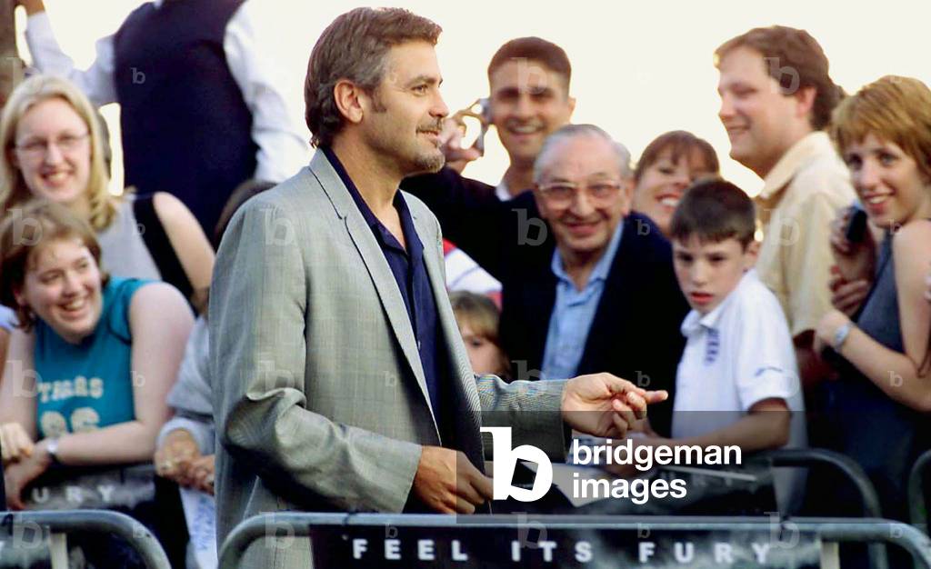 Image of American actor George Clooney is greeted by cheering fans as