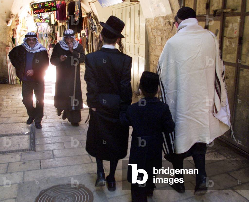 Image of A Jewish ultra-Orthodox man with his two sons and two