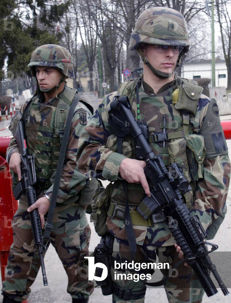 Image of UNITED STATES SOLDIERS STAND GUARD AT THE MAIN GATE OF