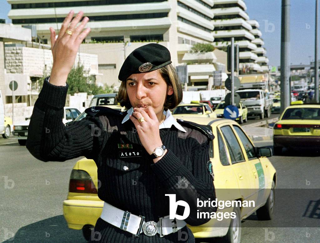 Image of Muna Hada, a Jordanian woman traffic police officer, directs ...