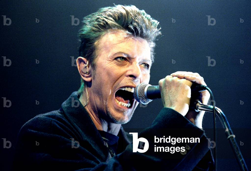 Image of British Pop Star David Bowie screams into the microphone as