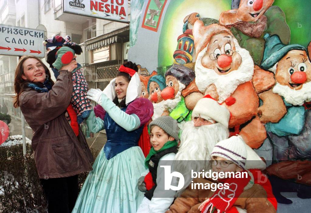 Image of AN ETHNIC ALBANIAN FAMILY IS POSING WITH SANTA CLAUS AND