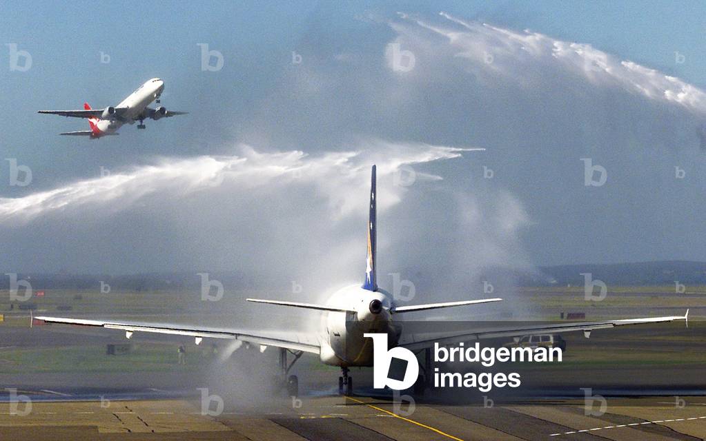 Image of An Ansett A320 passenger jet is sprayed with water from