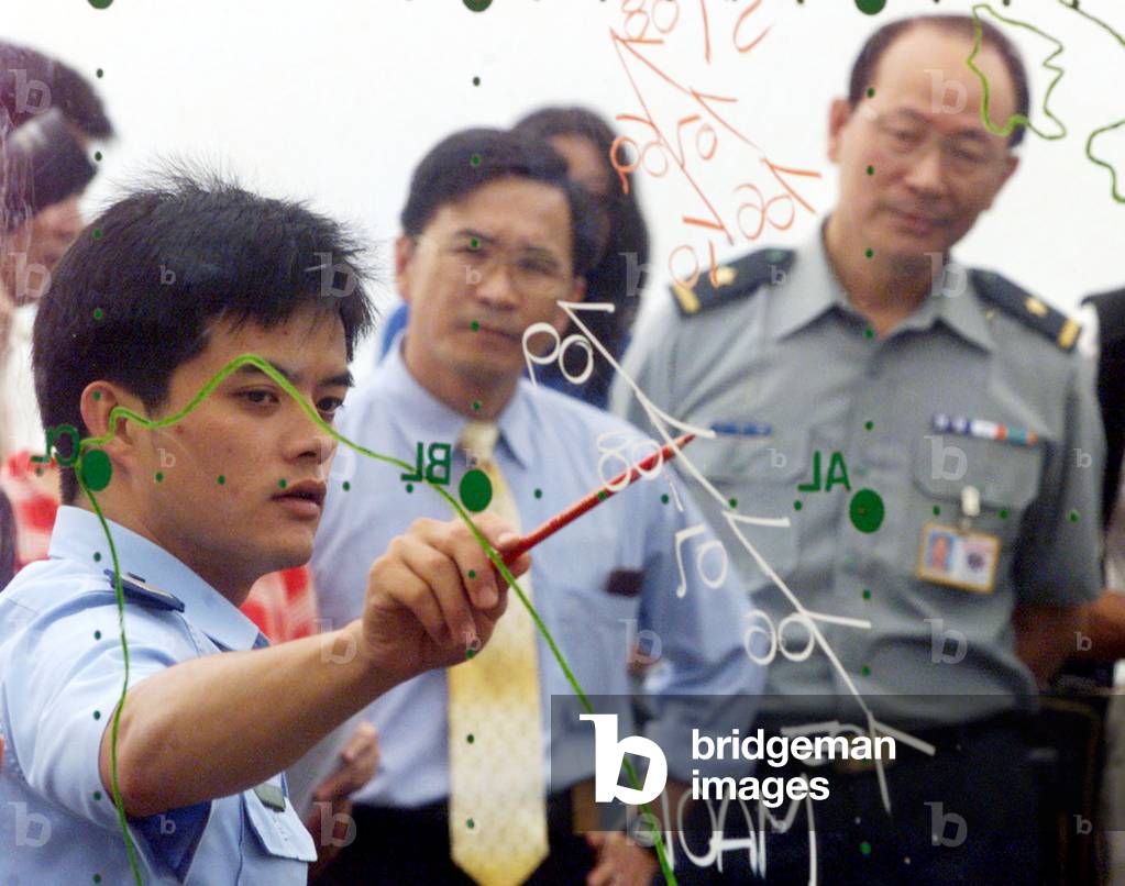 Image of TAIWAN AIR FORCE SERGEANT WU MING-FENG POINTS OUT THE FLIGHT