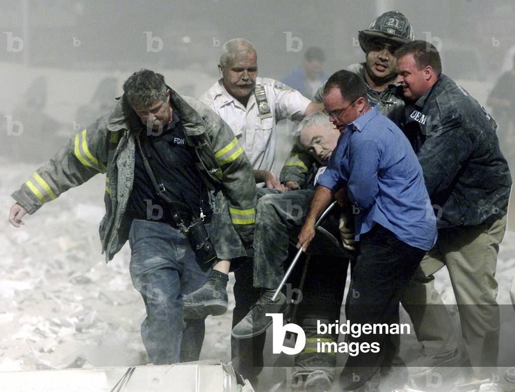 Image of Rescue workers remove a man from the World Trade Center