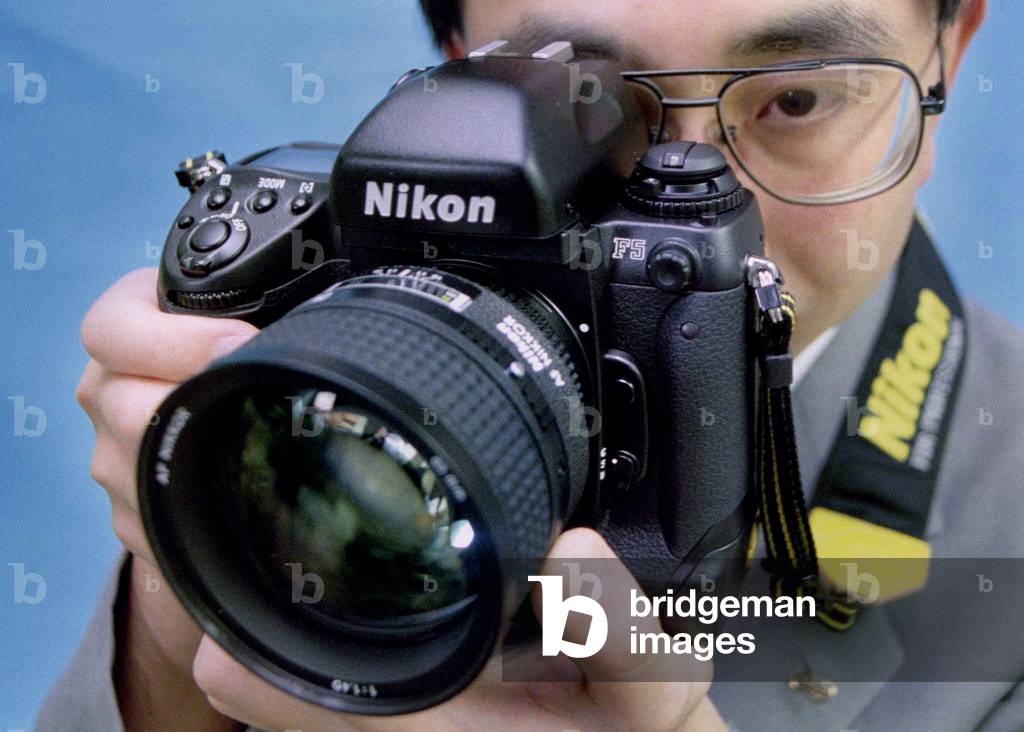 Image of Nikon Corp sales engineer Shigeru Hirano shows off Nikon's new