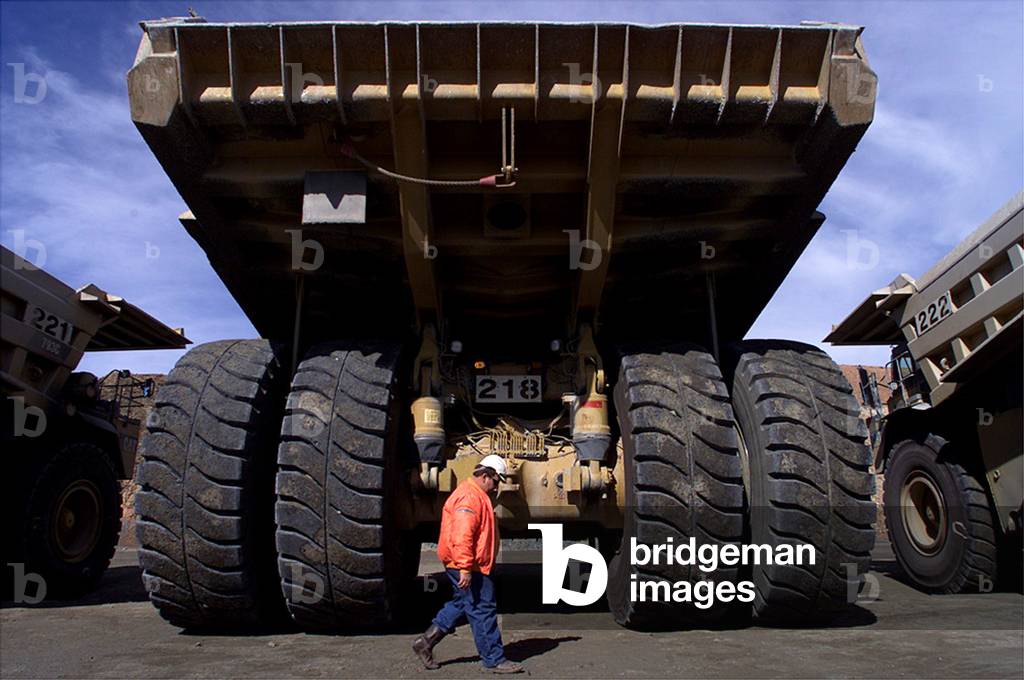 Image of GIANT MINING TRUCKS AT LARGEST OPEN PIT GOLD MINE IN