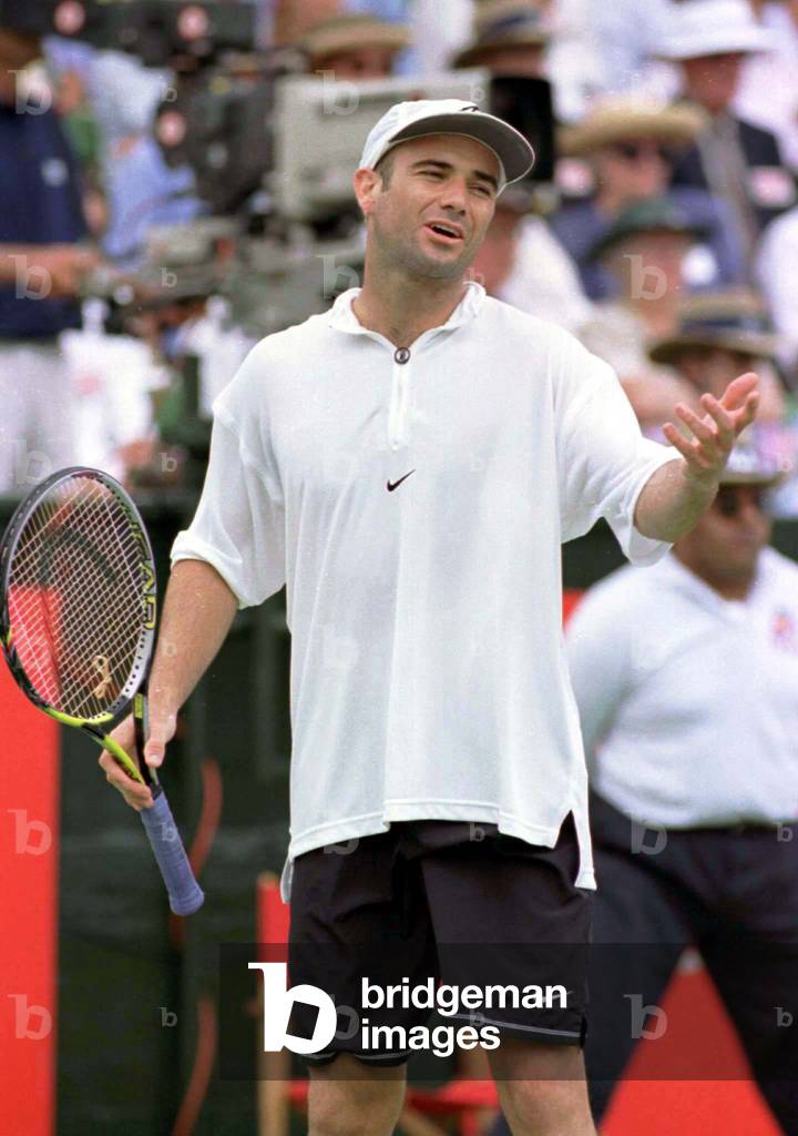 Image of AMERICAN ANDRE AGASSI GESTURES AFTER MISSING A SHOT AT THE