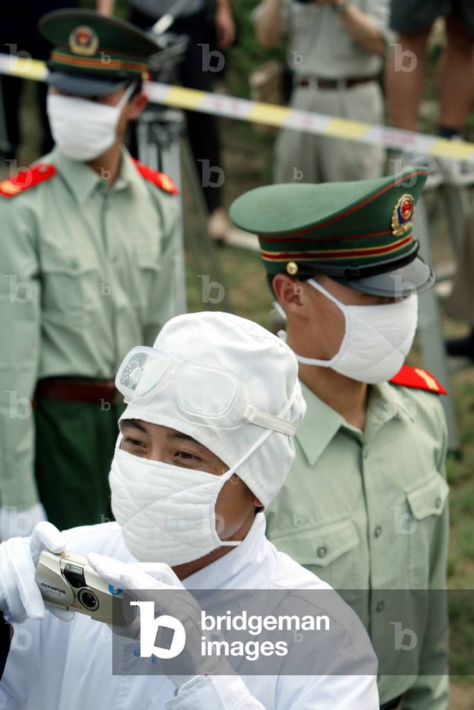Image of A MEDIC OF THE PEOPLE'S LIBERATION ARMY (PLA) TAKES PICTURES