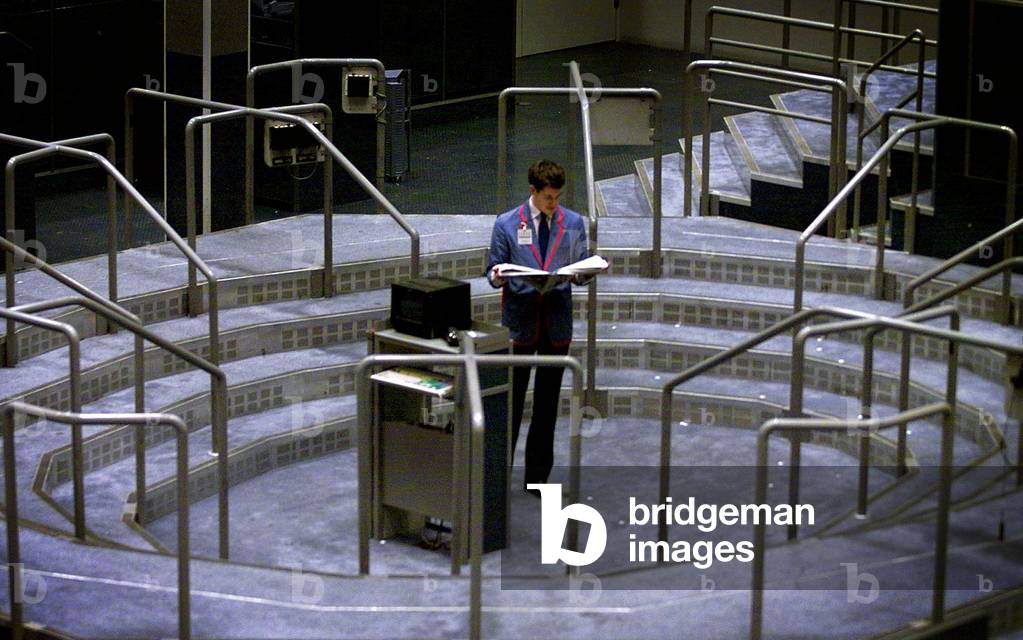 Image of A pit trader reads a newspaper in the empty open