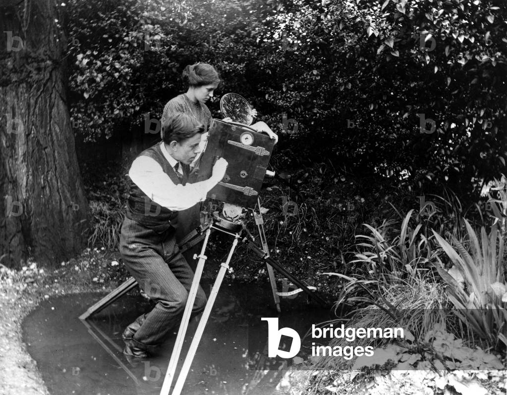 Image of F Percy Smith, English filmmaking pioneer, filming in a pond,