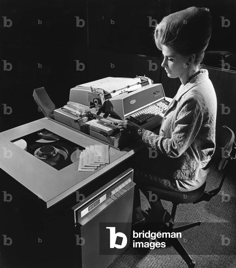 Image of Secretary with beehive hairstyle types at Friden Flexowriter, 1965