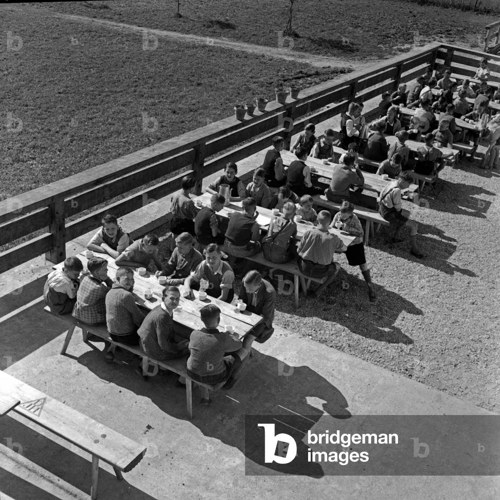 Boys sitting on the the sunny terrace of the Adolf Hitler youth hostel ...